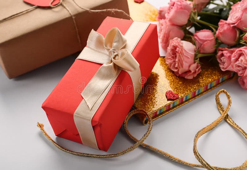 Beautiful Gift with Golden Notebook and Roses on Table. Valentines Day ...