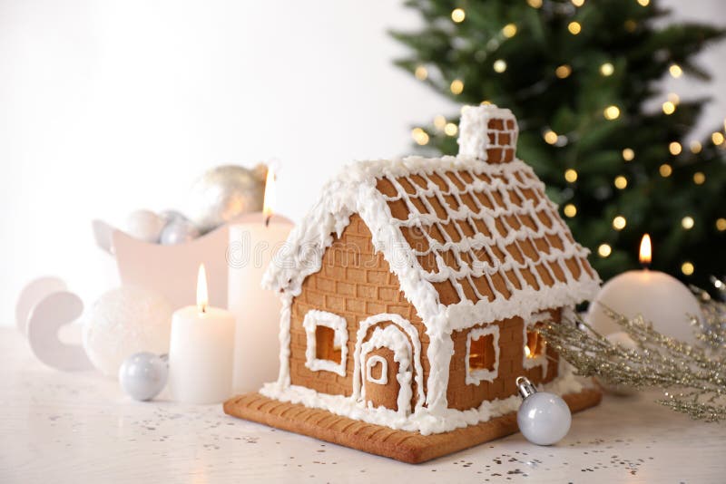 Beautiful Gingerbread House Decorated with Icing and Candles on White ...