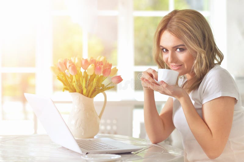 Beautiful Girl is Drinking Tea with a Laptop Stock Image - Image of ...