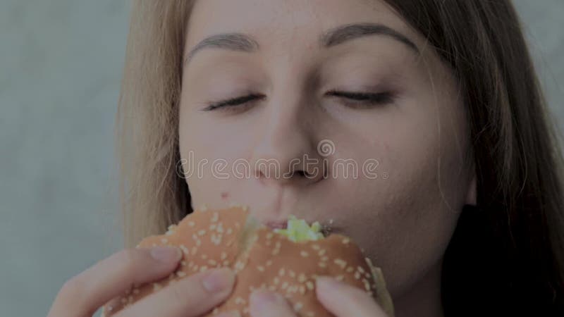 Beautiful Girl Eats a Burger. Fast Food Restaurant Stock Footage ...