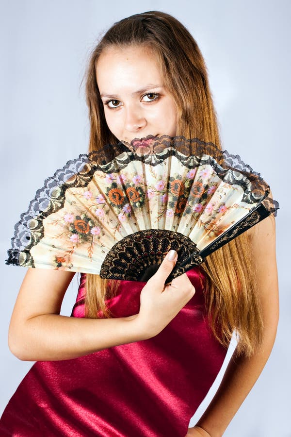 Beautiful girl with a fan. stock image. Image of dress - 18679219