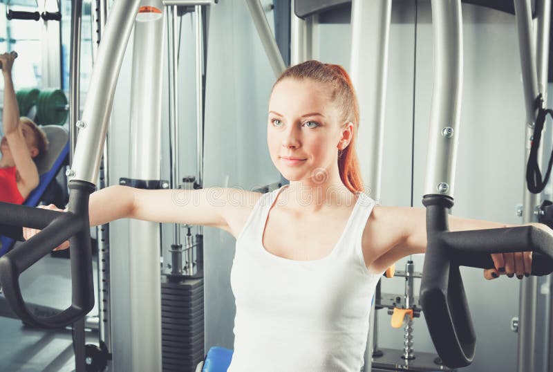 Beautiful Girl at the Gym Exercising on Trainers. Beautiful Girl Stock ...