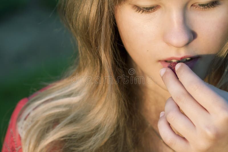 A Beautiful Girl Has a Raspberry Stock Photo - Image of cute, happy ...