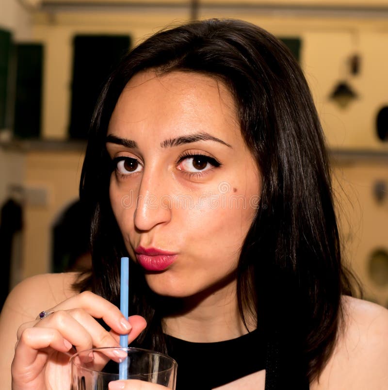 Beautiful Girl Looking Forward and Drinking Beverage Stock Photo ...