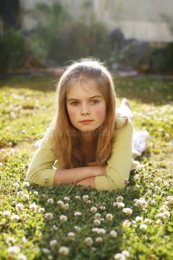 Beautiful Girl Lying on Grass Stock Photo - Image of serious, girl: 6377308