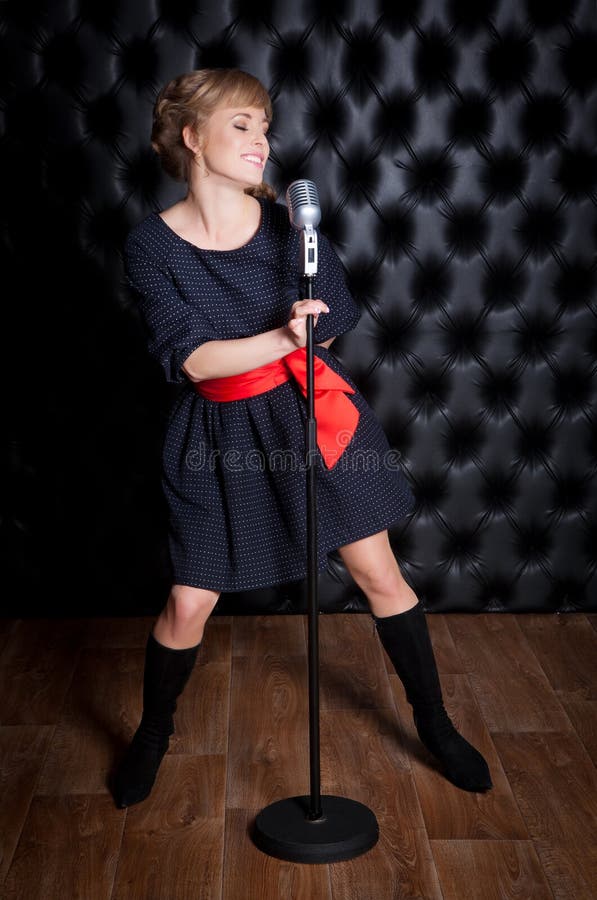 Beautiful Girl with a Microphone on Stage Stock Photo - Image of ...