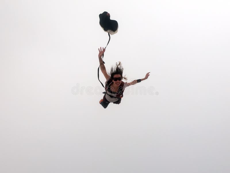 A Beautiful Girl Opening Her Parachute into the Clouds Stock Photo ...