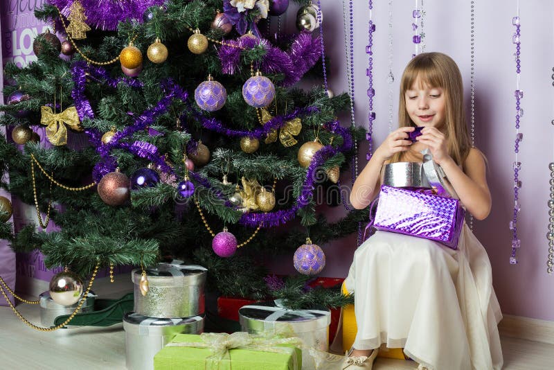 The Beautiful Girl Opens a Christmas Present Stock Image - Image of ...