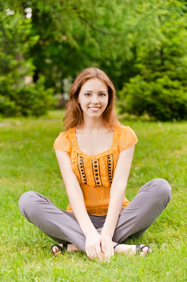 Beautiful Girl Sits on Lawn Stock Photo - Image of joyful, cute: 14610556