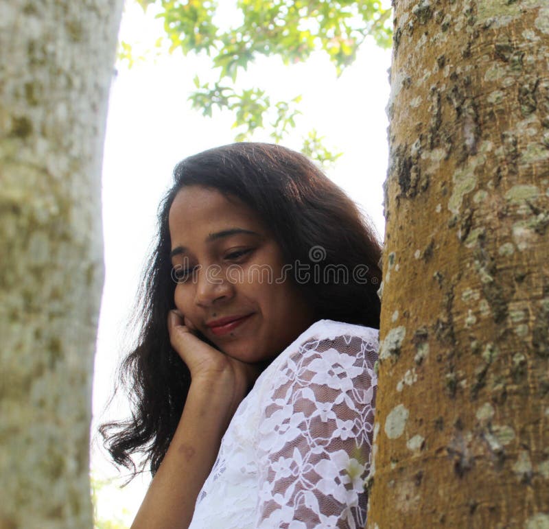The Beautiful Girl is Sitting Under a Tree Stock Photo - Image of tree ...