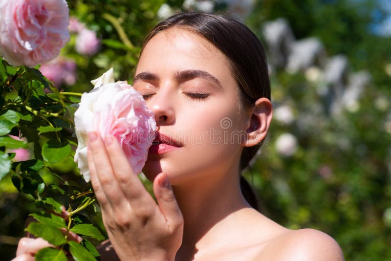 Beautiful Girl Smelling A Rose Flower In Spring Park Young Woman In