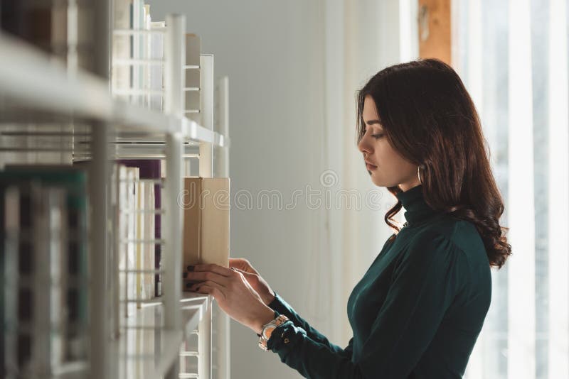 Beautiful girl taking book stock image. Image of young - 119814827