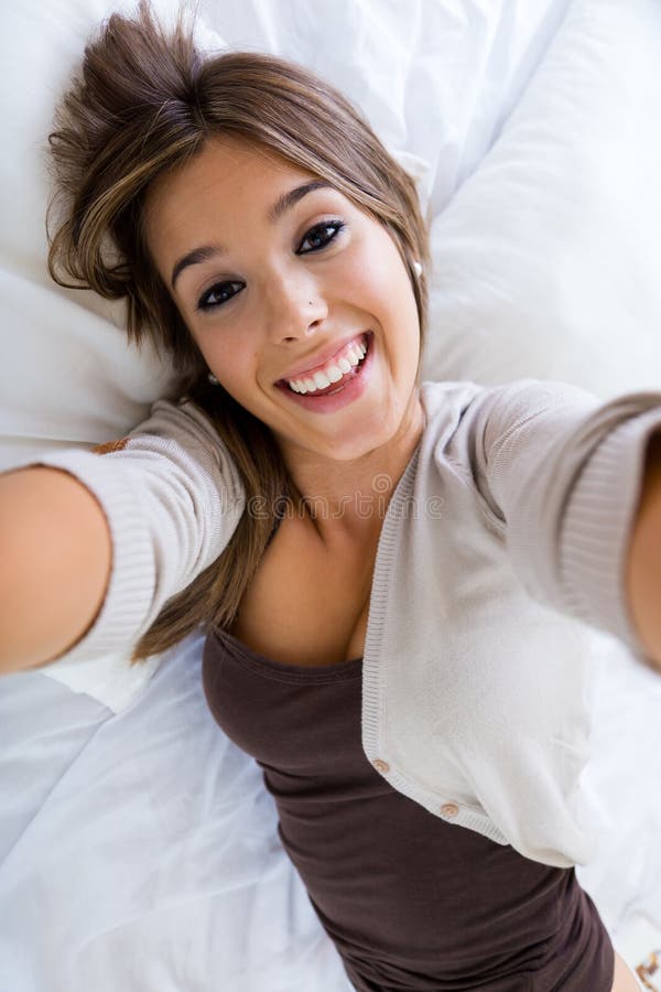 Beautiful Girl Taking A Self Portrait With Her Smartphone At Home