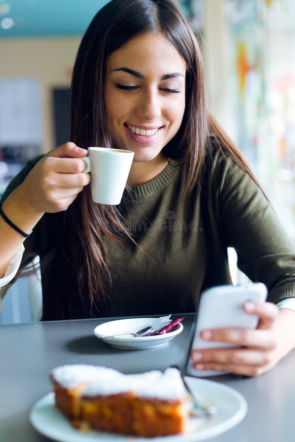 Beautiful Girl Using Her Mobile Phone in Cafe. Stock Image - Image of ...