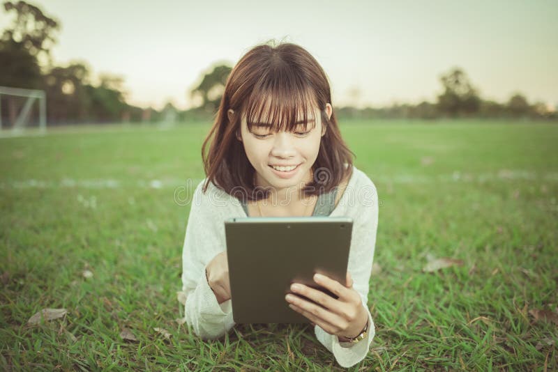 Beautiful Girl Using Tablet in Green Park Stock Image - Image of happy ...