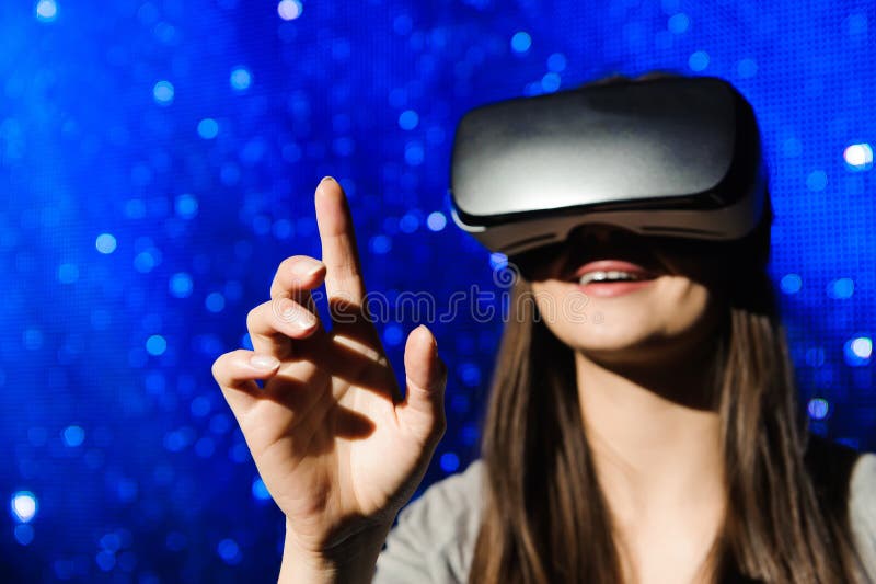 A Beautiful Girl Wearing a Virtual Reality Device, Standing on the ...