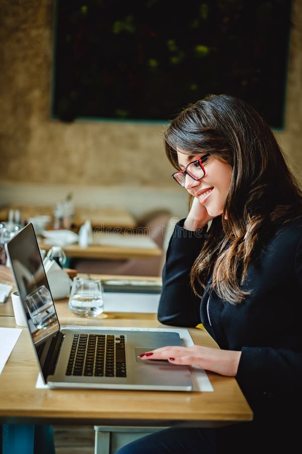 Beautiful Girl Working on Laptop in a Cafe Stock Image - Image of ...