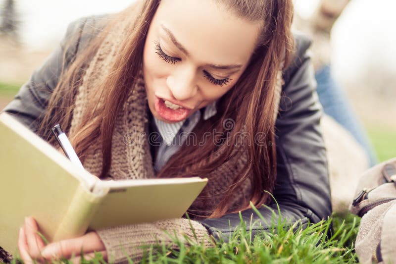Beautiful Girl Writing in a Book Stock Image - Image of happy ...