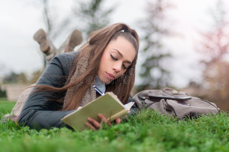 Beautiful Girl Writing in a Book Stock Image - Image of enjoying ...