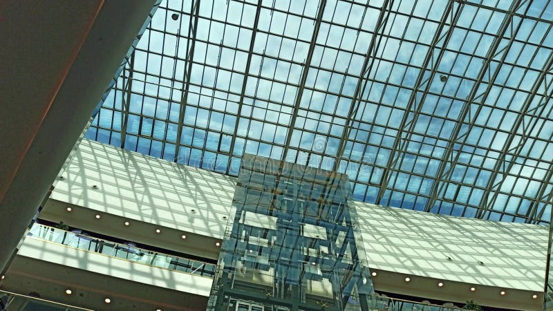 Beautiful Glass Elevator with Reflection in Big Shopping Mall with Blue ...