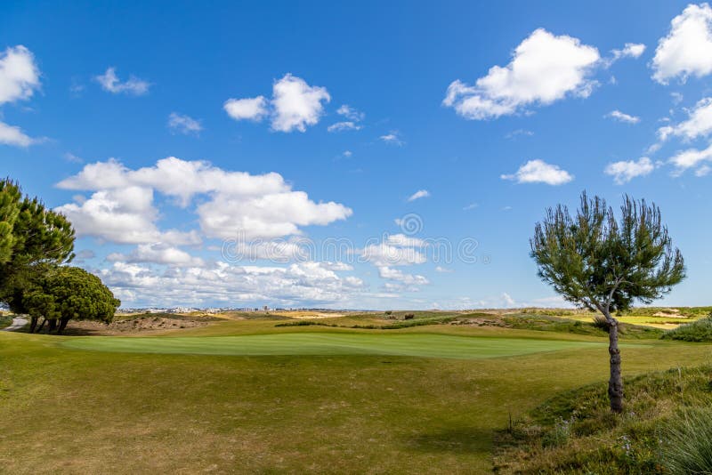 Beautiful Golf Course Under a Blue Sky with Clouds Stock Image - Image ...
