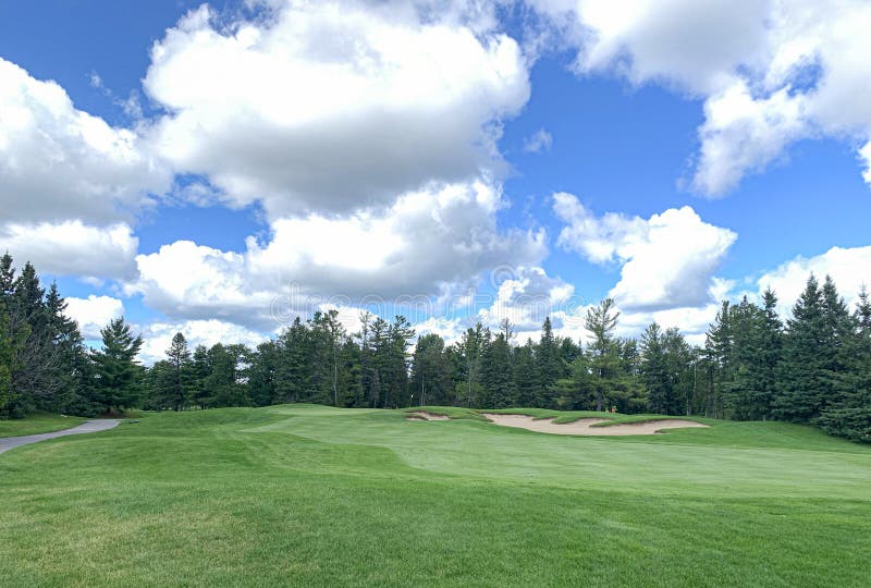 A Beautiful Green Golf Course and Blue Cloudy Sky on a Beautiful Summer ...