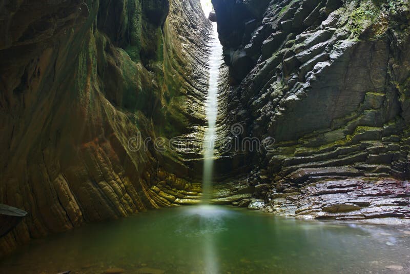 Beautiful Grotto with Pouring Beautiful Waterfall Stock Photo - Image ...