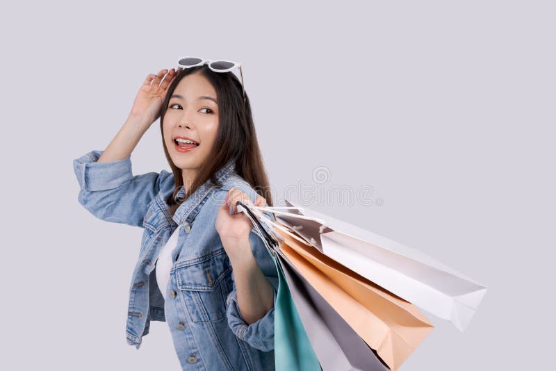 Beautiful Happy Asian Woman Carrying A Shopping Bag And Sunglasses