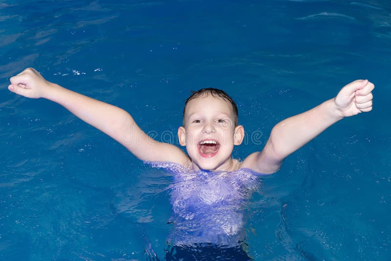 A Beautiful Happy Boy Swims in the Pool Stock Photo - Image of ...