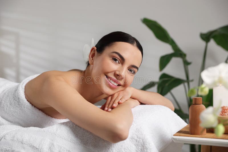 Beautiful Happy Woman Relaxing On Massage Table In Spa Salon Stock