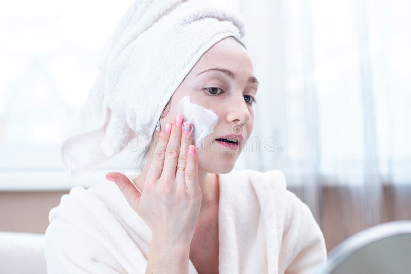 Beautiful Happy Young Woman Applying Cream On Face Moisturizing The
