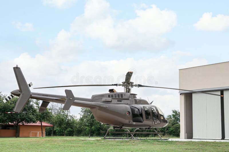 Beautiful Helicopter on Helipad Near White Hangar Stock Photo - Image ...