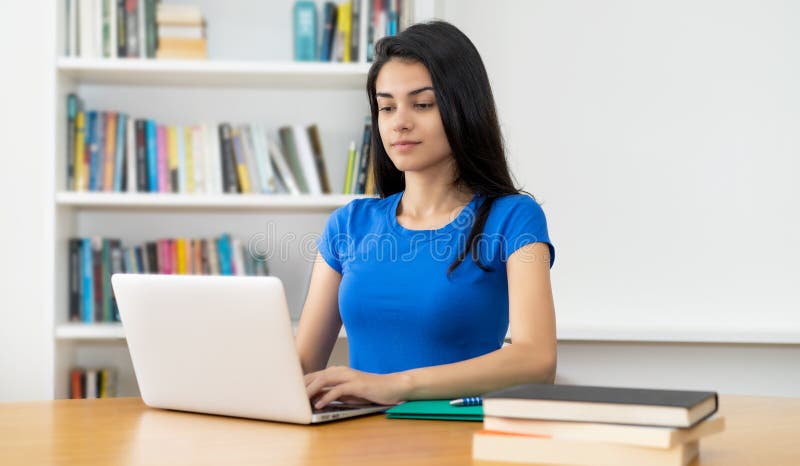 Beautiful Hispanic Female Student Learning Online at Computer Stock ...