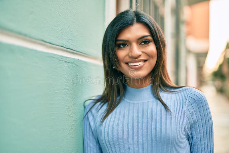 Beautiful Hispanic Woman Smiling Confient Leaning on the Wall Stock ...
