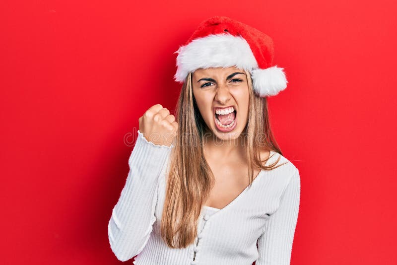 Beautiful Hispanic Woman Wearing Christmas Hat Angry And Mad Raising