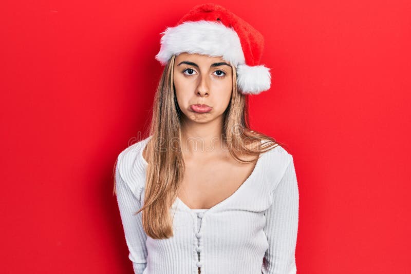 Beautiful Hispanic Woman Wearing Christmas Hat Depressed And Worry For