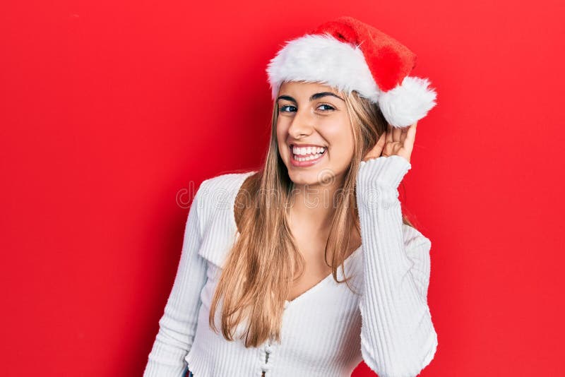 Beautiful Hispanic Woman Wearing Christmas Hat Smiling With Hand Over