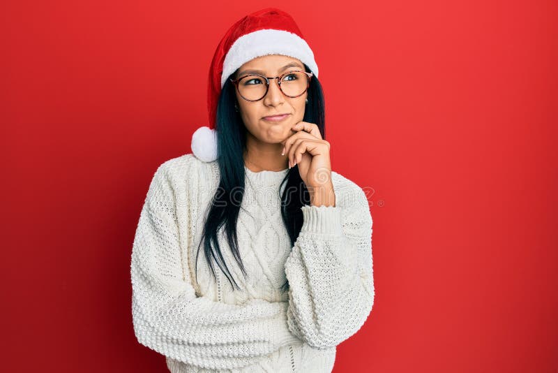 Beautiful Hispanic Woman Wearing Christmas Hat Thinking Concentrated