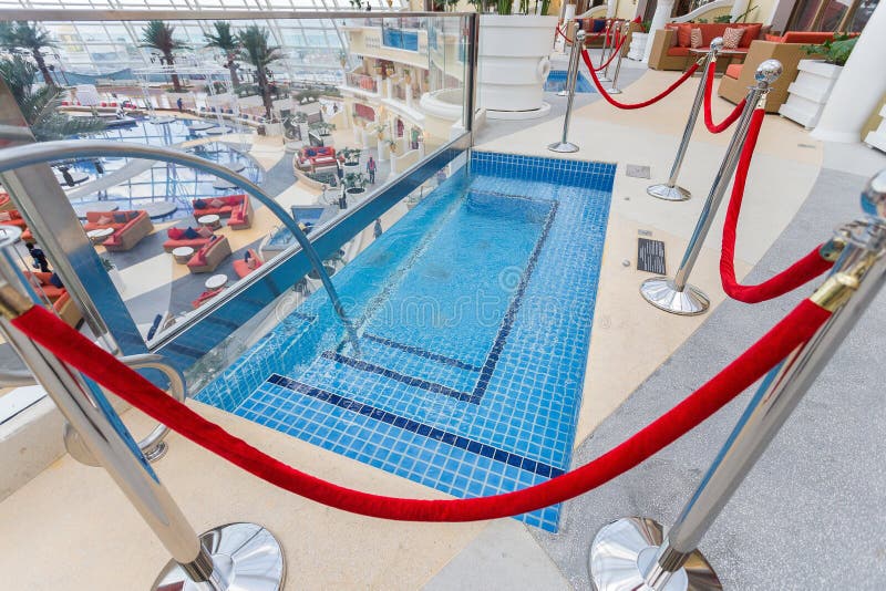 Beautiful Indoor Swimming Pool with Artificial Trees and Chairs and ...