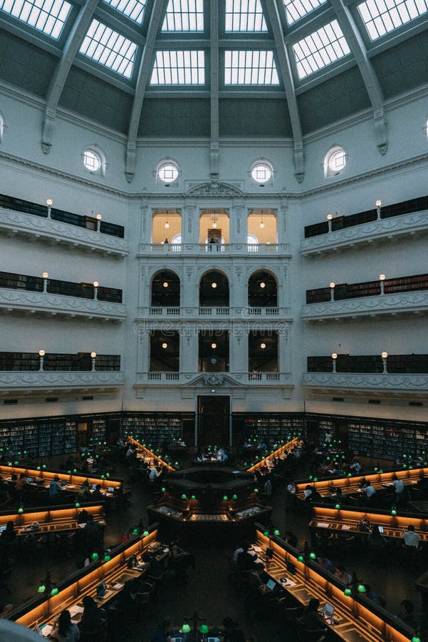 Beautiful Interior of a Large Library with People Working on Laptops ...