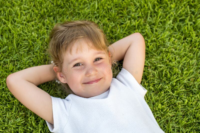 Beautiful Kid Laying on the Grass in the Park Stock Photo - Image of ...