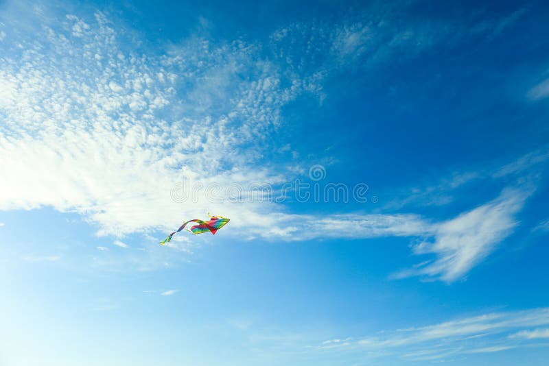 Beautiful Colorful Kite Flying In A Blue Cloudy Sky Stock Image - Image ...