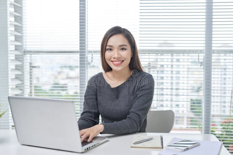 A Beautiful Lady Sitting at a Table. Office Life Stock Image - Image of ...