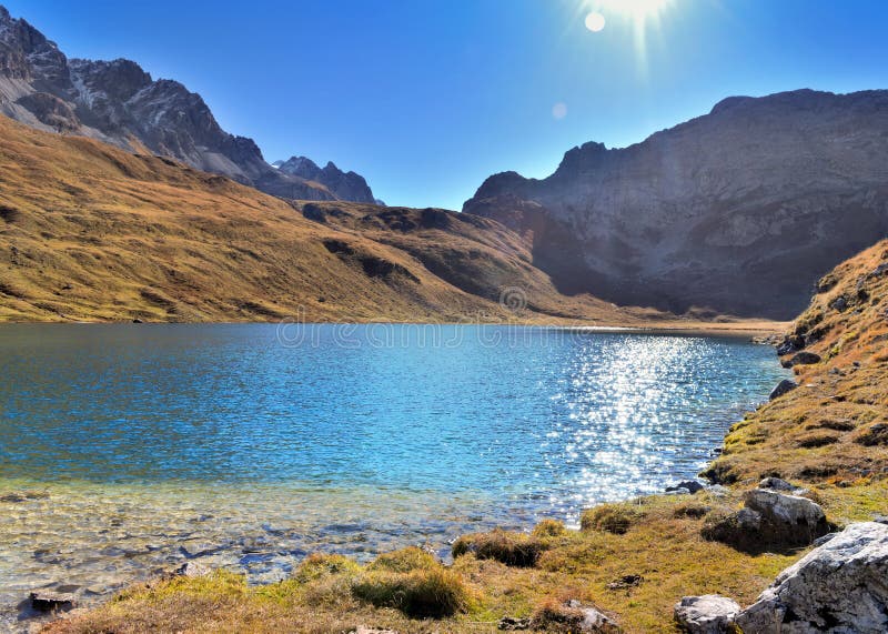 Lake in Alpine Mountain Lake with the Reflection of the Sun on the ...
