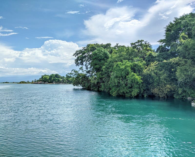 Beautiful Lakeside View and Trees Against a Bright Blue Sky Background ...