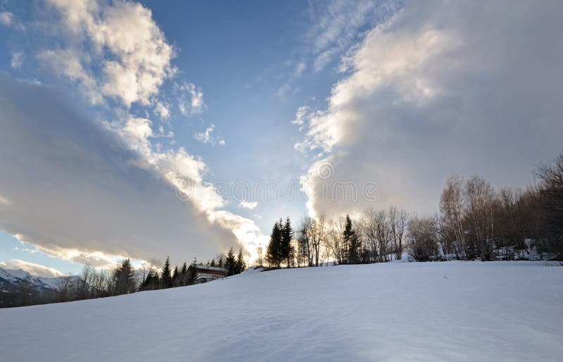 Landscape of Mountain Covered with Snow with Cloudy Sky and Sunlight in ...
