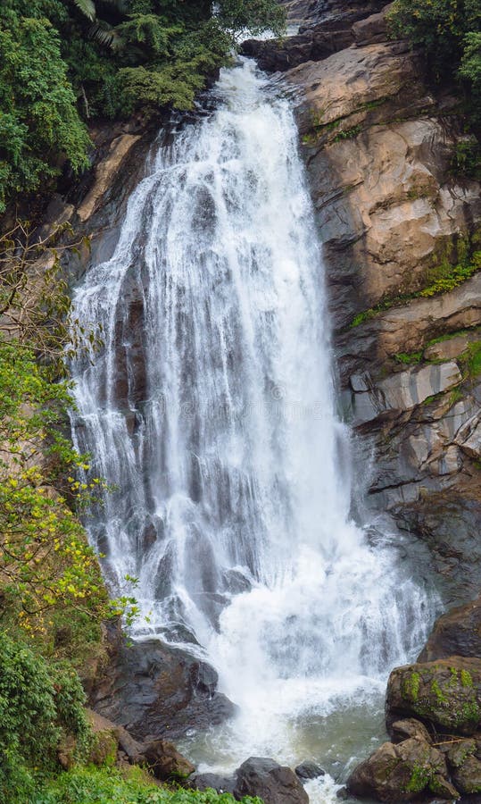 A Beautiful Large Waterfall is Crashing Down from a Rock Cliff Stock ...