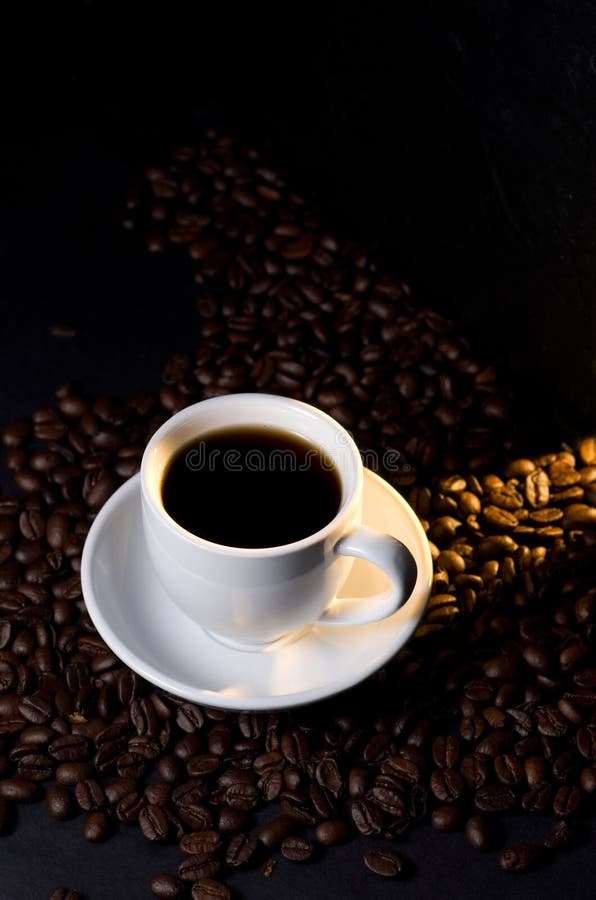 Beautiful Light on White Coffee Cup Surrounded by Coffee Beans Stock ...