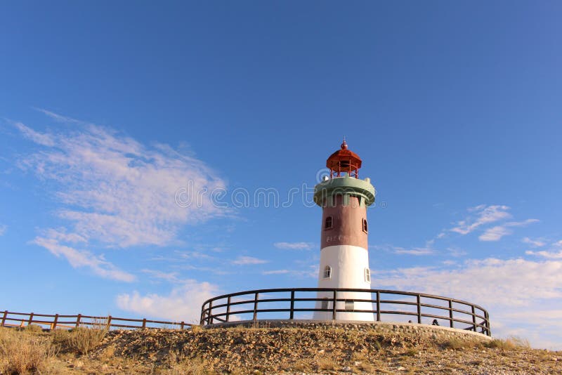 Beautiful Lighthouse Atop a Hill Overlooking the Ocean Stock Image ...