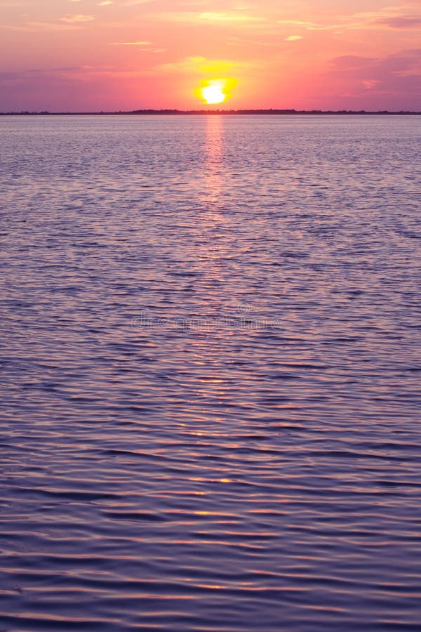 Beautiful Lilac Sunset and Calm Waves on the Lake Stock Image - Image ...